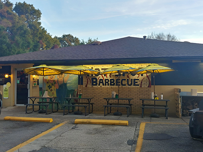 The unassuming exterior of Hot Spot Barbecue proves once again that the best barbecue joints often hide behind modest facades. Those yellow umbrellas practically whisper, "Smoke signals ahead!"