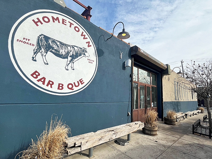 The blue exterior with its vintage cow logo isn't just a restaurant front&mdash;it's a beacon of smoke-scented hope for barbecue pilgrims seeking meaty salvation. 