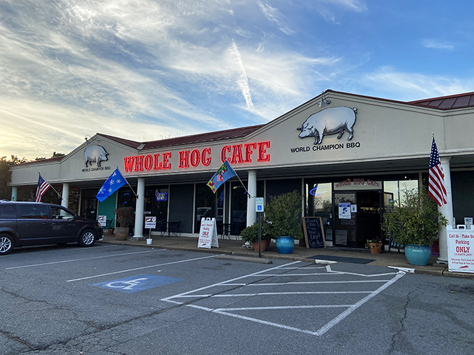 The promise of BBQ bliss beckons from this unassuming storefront. Whole Hog's iconic red sign stands like a carnivore's North Star against Arkansas skies.