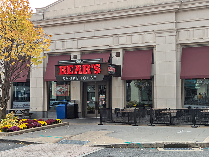 The stone facade of Bear's Smokehouse stands like a temple to barbecue, its bold red sign a beacon to hungry pilgrims seeking smoky salvation.