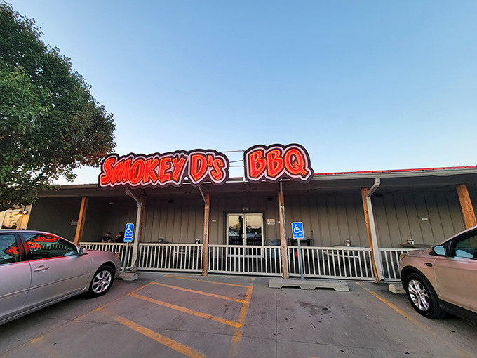 The unassuming exterior of Smokey D's BBQ, where the parking lot's always full and that heavenly smoke aroma greets you before the door does.