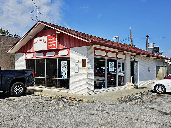 The modest red and white exterior of Hartland Bar-B-Que speaks the universal truth of BBQ: the less fancy the building, the better the meat inside.