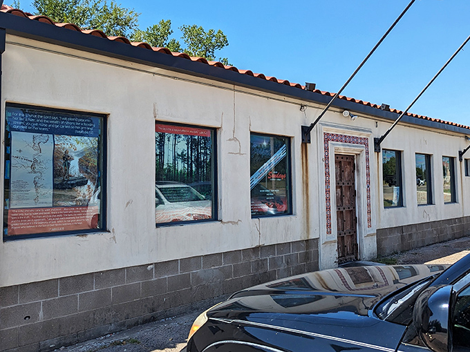 Three flags flutter proudly outside this unassuming barbecue sanctuary, where the red tile roof and stucco walls hide smoky treasures within.