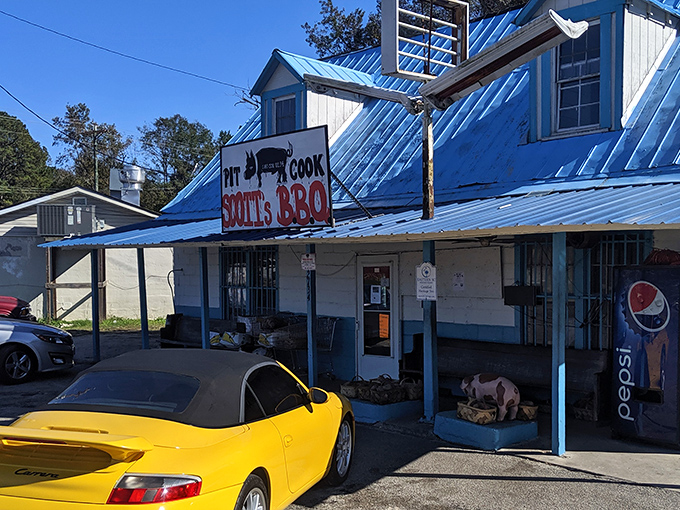 The pilgrimage destination itself: Scott's Bar-B-Que stands proudly with its metal roof and blue-trimmed exterior, a humble temple to smoked meat perfection.