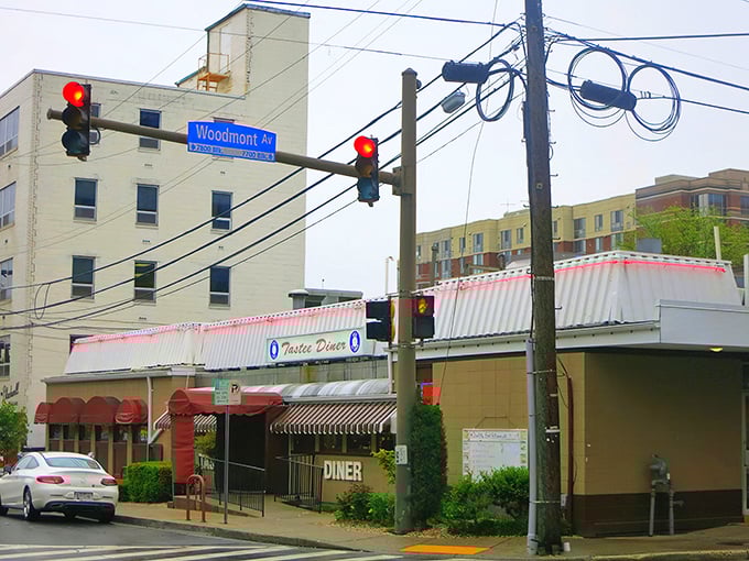 The stainless steel exterior of Tastee Diner stands defiant against time, its red and white awning a beacon for breakfast pilgrims seeking authenticity in Bethesda.