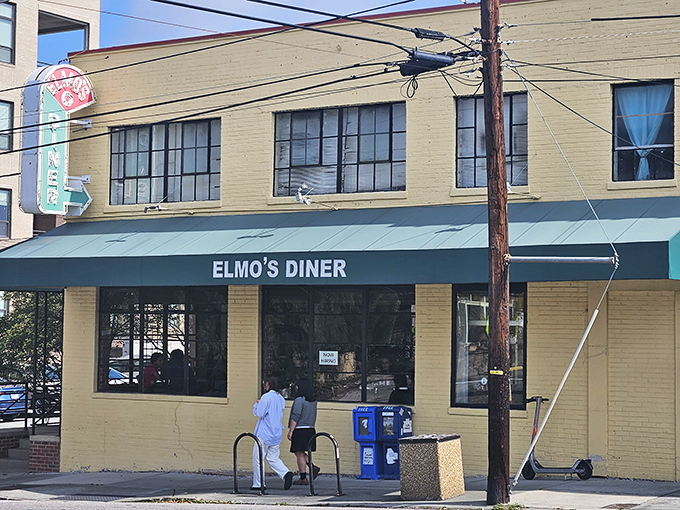 The unassuming yellow exterior of Elmo's Diner stands like a beacon of breakfast hope on Durham's Ninth Street, promising comfort within its walls.
