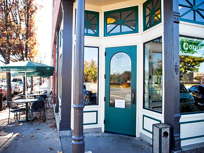The iconic teal-trimmed entrance of Community Bakery beckons like an old friend, promising carb-laden treasures behind that glowing "OPEN" sign.