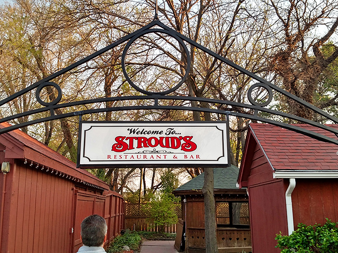 The wrought iron archway welcomes you like an old friend's embrace. Stroud's red exterior promises comfort food treasures waiting just beyond those wooden doors.