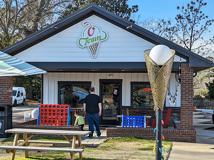The classic ice cream parlor facade of O Town beckons like a sweet mirage on a hot Alabama day, complete with charming outdoor seating.