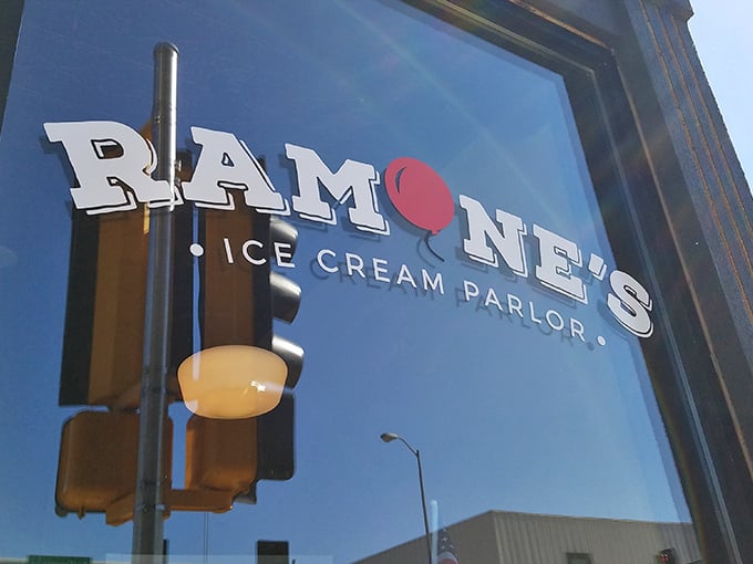 The classic black storefront with that striking red door is like finding the entrance to Willy Wonka's factory hiding in plain sight on a Wisconsin street corner.