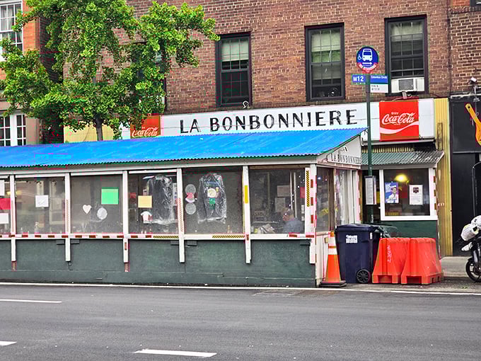 La Bonbonniere's weathered fa&ccedil;ade stands as a time capsule in the West Village, its vintage sign promising the holy trinity of comfort: burgers, snacks, and fountain treats.