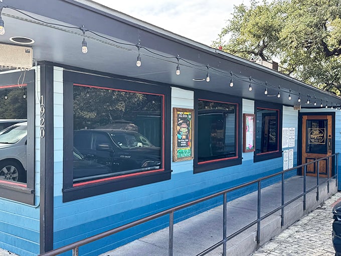 The iconic blue exterior of Magnolia Cafe stands as an Austin landmark, its welcoming porch and signature sign beckoning hungry pilgrims at all hours.