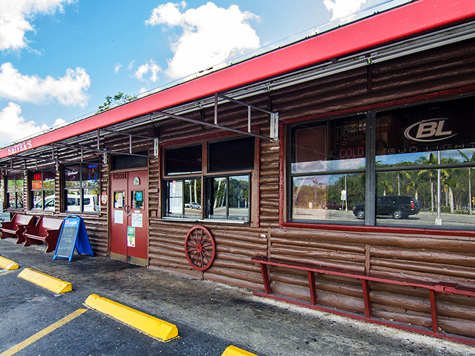 The log cabin exterior with its bright red trim stands like a delicious mirage in Homestead, promising smoky treasures within. Florida's answer to barbecue paradise.