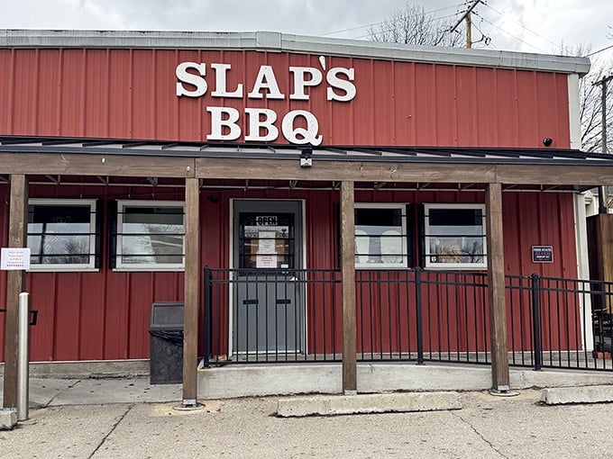 The iconic red exterior of Slap's BBQ stands as a beacon of hope for hungry pilgrims seeking smoky salvation in Kansas City's competitive barbecue landscape.
