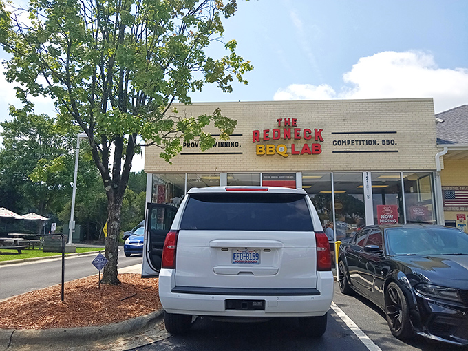 The white brick exterior with bold red and yellow signage announces what you're in for: serious barbecue wrapped in a playful scientific package.
