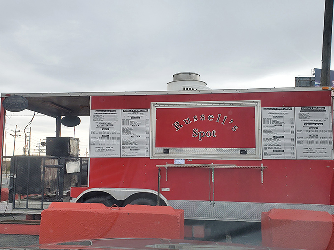 The bright red food truck stands like a culinary lighthouse in the parking lot, beckoning hungry souls with promises of smoky delights.