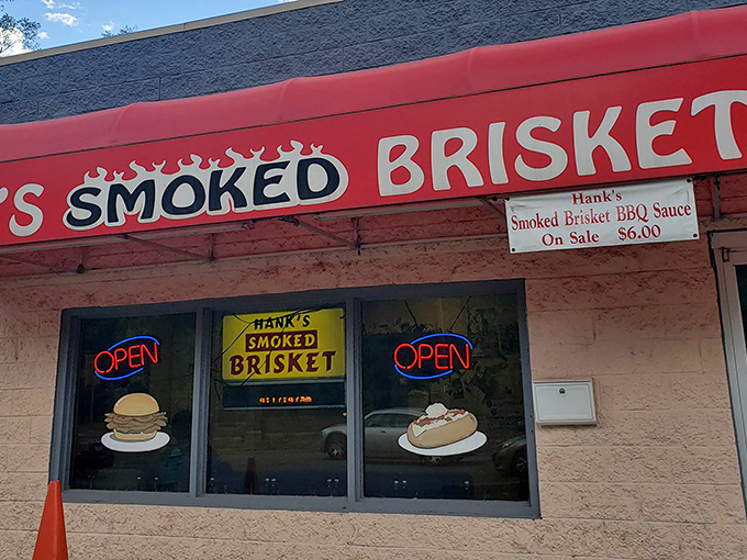 The bright red awning of Hank's stands out like a beacon for barbecue pilgrims, promising smoky salvation inside this unassuming Indianapolis treasure.