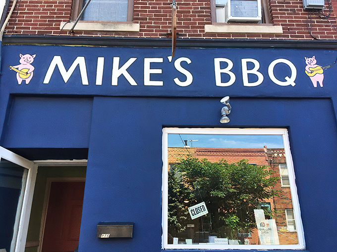 The blue storefront with cartoon pigs playing banjos isn't just cute &ndash; it's a beacon of smoky promise in South Philly's culinary landscape.