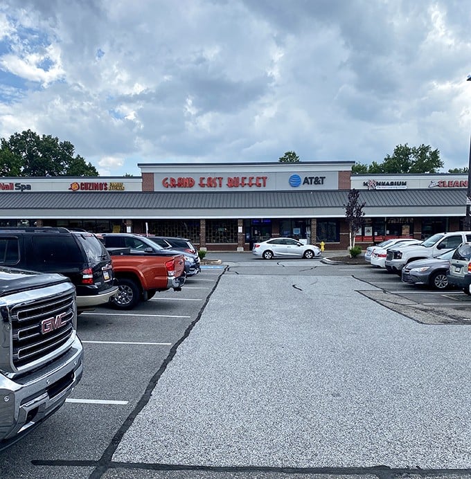 The bold red lettering of Grand East Buffet beckons hungry patrons like a lighthouse guiding ships to harbor. This unassuming strip mall location houses a treasure trove of culinary delights.