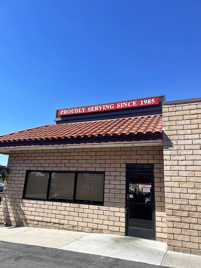 The red-tiled roof and brick facade of Old Time Drive In stands as a beacon of comfort food in Sun Valley, where California sunshine meets classic American dining.