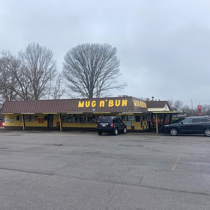 The bright yellow "MUG n BUN" sign stands as a beacon of hope for burger lovers who know that sometimes the best meals come from the most unassuming places.