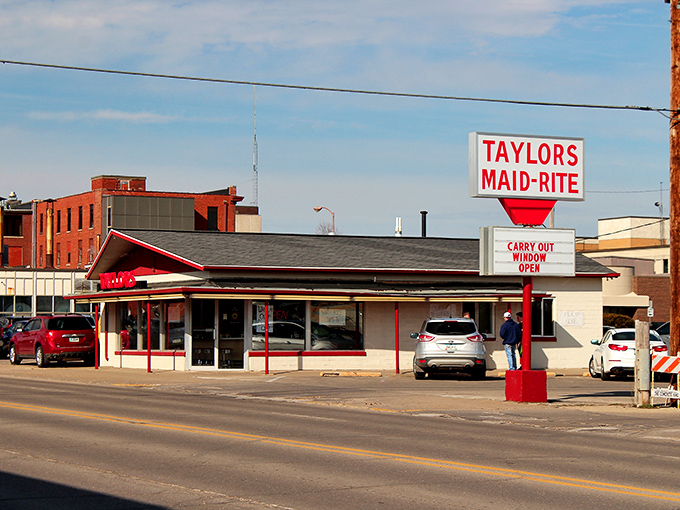 The classic red and white exterior of Taylor's Maid-Rite stands as a beacon of culinary tradition in downtown Marshalltown, promising loose-meat perfection within.