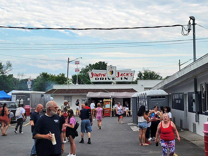 The iconic Jumpin' Jack's sign stands proudly against dramatic skies, while Old Glory waves from a fire truck ladder&mdash;a Scotia summer tradition in full swing.