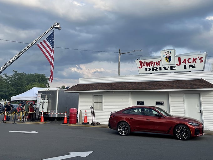 The iconic Jumpin' Jack's sign stands proudly against dramatic skies, while Old Glory waves from a fire truck ladder&mdash;a Scotia summer tradition in full swing.