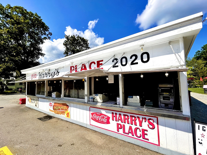 The white facade of Harry's Place stands like a culinary lighthouse, beckoning hungry travelers with its iconic red lettering and promise of roadside bliss.
