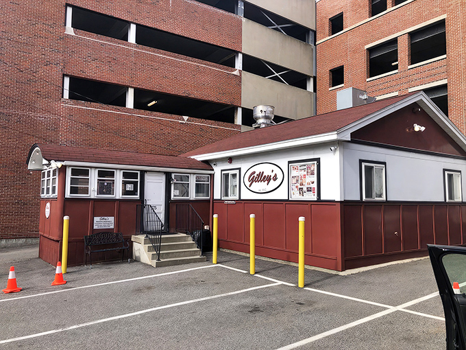 Gilley's stands proudly against Portsmouth's modern backdrop, a time-traveling red lunch car that refuses to be overshadowed by the parking garage behind it.