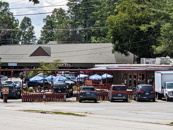 The iconic Cardinal Drive-In sign stands tall against the Carolina blue sky, beckoning hungry travelers with its retro charm and promise of comfort food paradise.