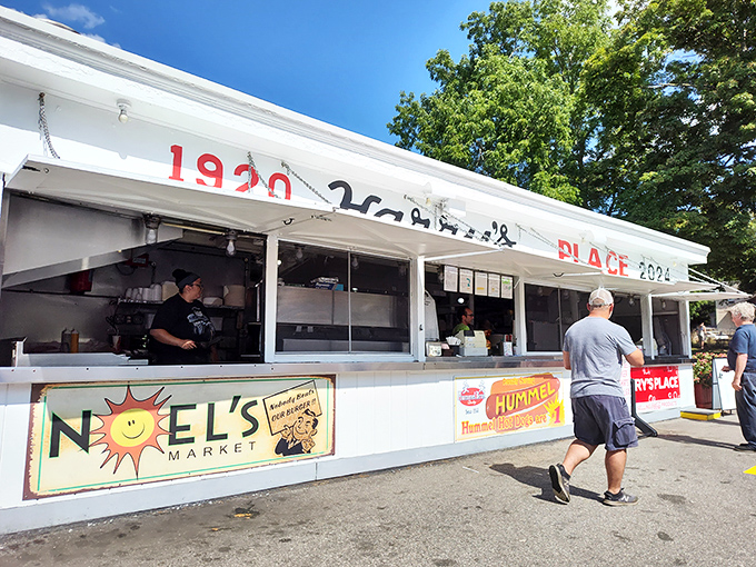 The white facade of Harry's Place stands like a culinary lighthouse, beckoning hungry travelers with its iconic red lettering and promise of roadside bliss.