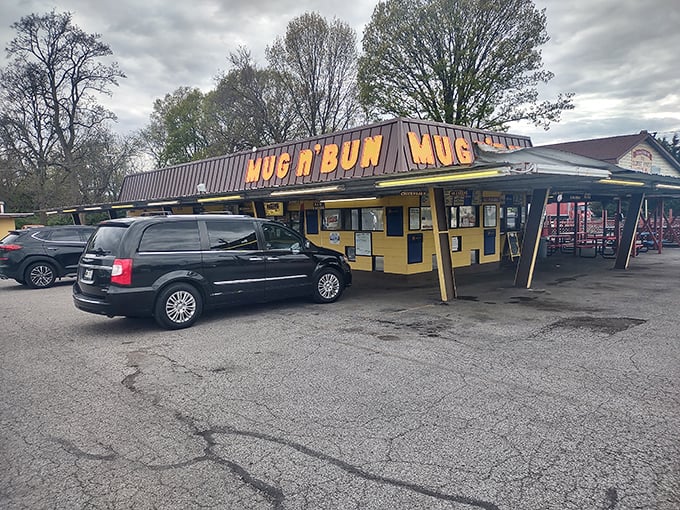 The bright yellow "MUG n BUN" sign stands as a beacon of hope for burger lovers who know that sometimes the best meals come from the most unassuming places.