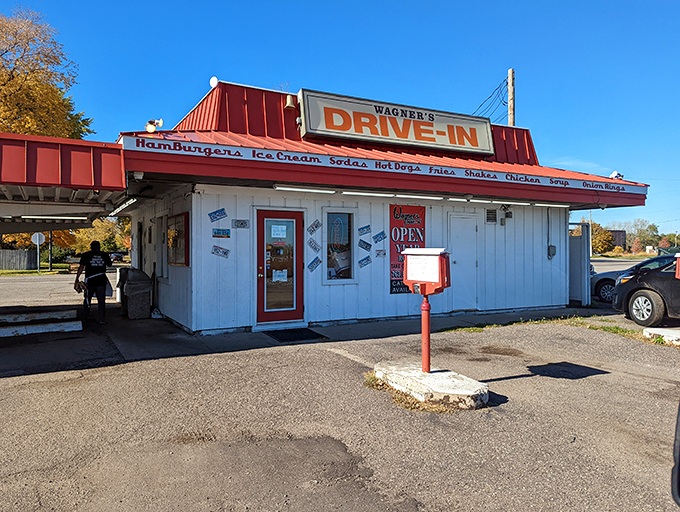 The iconic red-roofed Wagner's Drive-In stands like a time portal to simpler days, beckoning hungry travelers with promises of hand-crafted burgers and nostalgia by the plateful.
