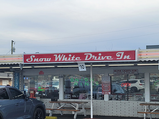 The iconic red sign beckons hungry travelers like a neon lighthouse. Snow White Drive In has been Lebanon's comfort food beacon since the Eisenhower administration.