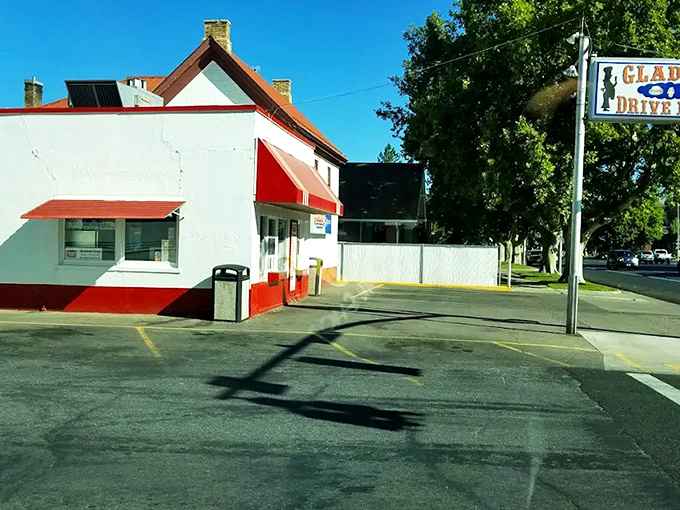 The classic red and white exterior of Glade's stands like a time capsule on Spanish Fork's corner, beckoning hungry travelers with nostalgic charm.