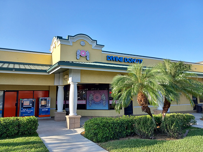The sunshine-yellow exterior of Divine Donuts stands out like a beacon of hope for the sugar-deprived, complete with their angelic donut logo promising heavenly treats inside.