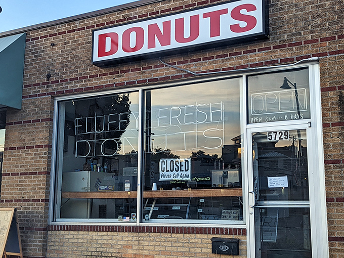 The brick facade and neon sign of Fluffy Fresh Donuts stands as a beacon of sweet promises on Johnson Drive. Mission accomplished!