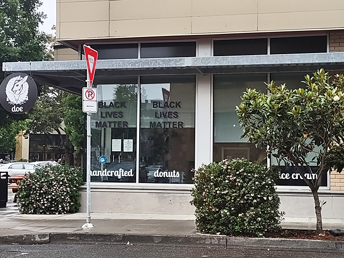 The storefront beckons with its clean lines and promise of handcrafted delights. Black Lives Matter signs show this is a place with both conscience and confections. 