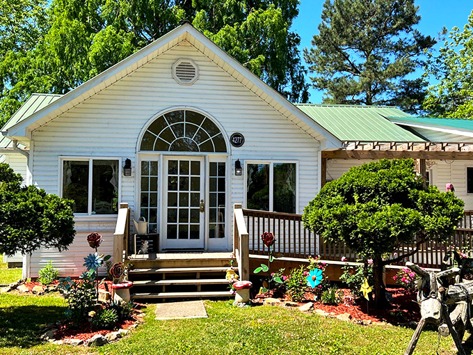 A storybook cottage come to life, The Hatter Cafe's charming exterior welcomes you with a wooden porch, colorful flowers, and the promise of culinary adventures.
