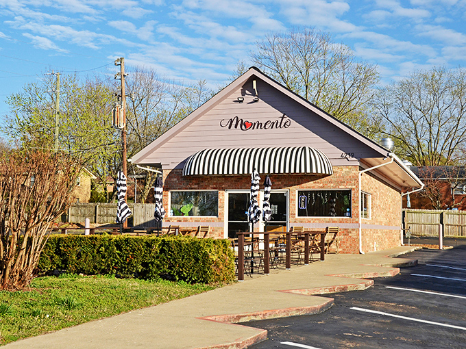A brick cottage with a striped awning that whispers, "Come inside, we've got something special brewing." This charming exterior hides Tennessee's best-kept breakfast secret.