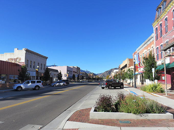 Historic brick buildings line Main Street in Ca&ntilde;on City, where Pizza Madness offers a slice of local flavor amid architecture that whispers tales of Colorado's past.