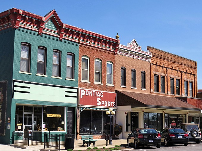 Twilight transforms downtown Pontiac into a scene from a Rockwell painting, where vintage storefronts glow with promise and history whispers from every brick.