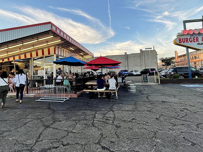 The retro-futuristic design of Boulevard Burger & Brew beckons like a time machine disguised as a diner. Those colorful umbrellas aren't just for show—they're happiness markers.