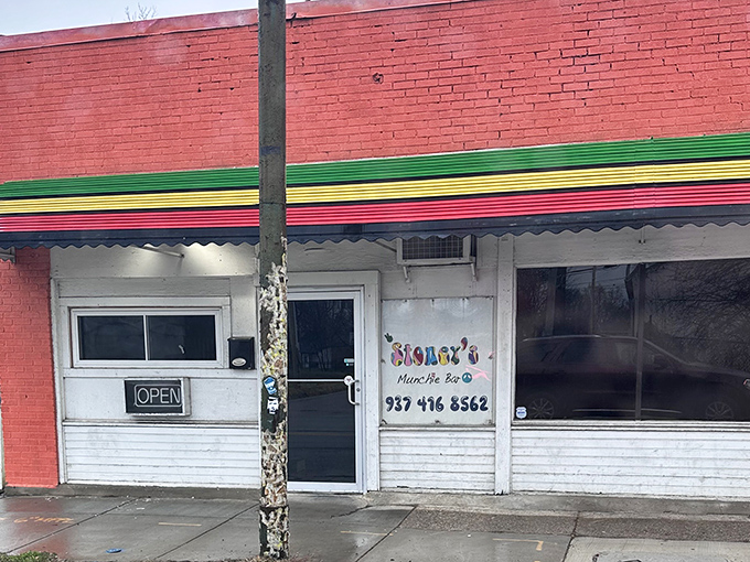 The unassuming brick exterior with its vibrant Jamaican-inspired trim is like a culinary treasure map &ndash; X marks the spot where flavor lives.
