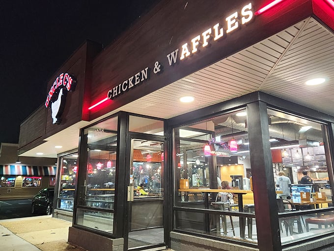 The glowing sign of Uncle C's beckons hungry travelers like a lighthouse for the famished. Modern exterior with classic comfort food promise.
