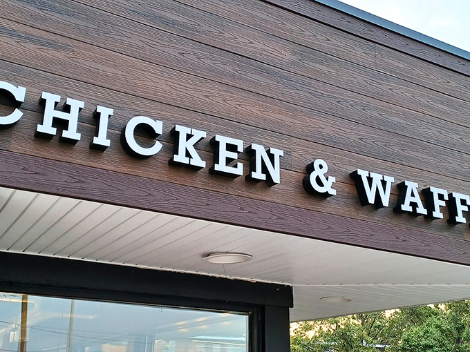 The glowing sign of Uncle C's beckons hungry travelers like a lighthouse for the famished. Modern exterior with classic comfort food promise.