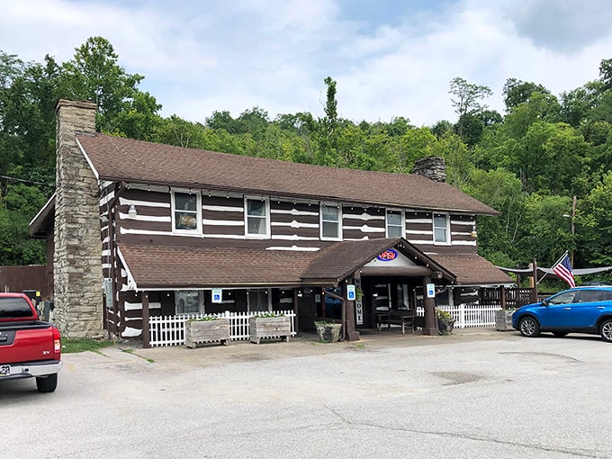 The iconic Log Cabin Inn exterior showcases authentic cabin architecture with its distinctive brown and white pattern—Kentucky comfort food headquarters in architectural form.