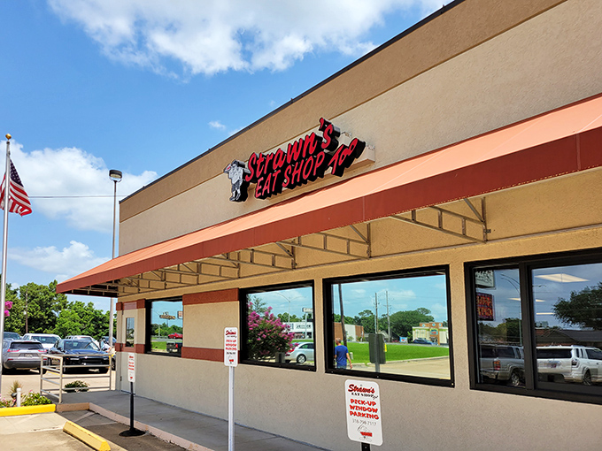 The exterior of Strawn's Eat Shop Too stands proudly against the Louisiana sky, a beacon of comfort food that's been calling hungry diners home for generations. 