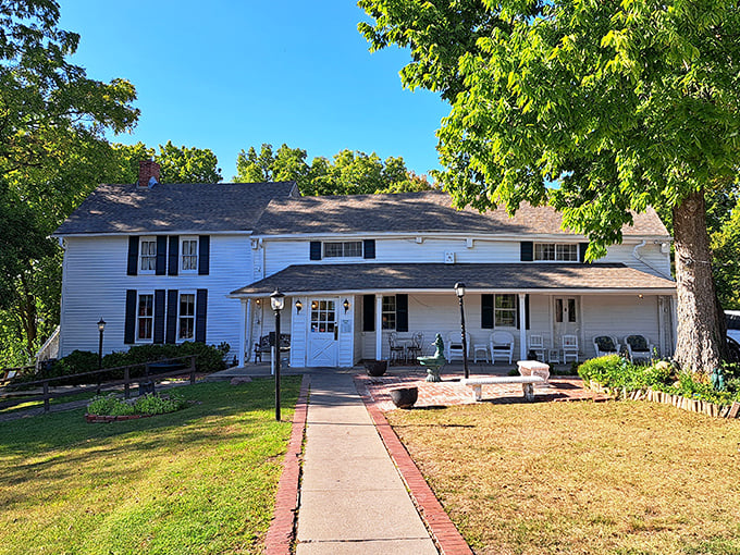 The white clapboard exterior of Stroud's Oak Ridge Manor stands like a time capsule of Americana, promising comfort food treasures within its unassuming walls.